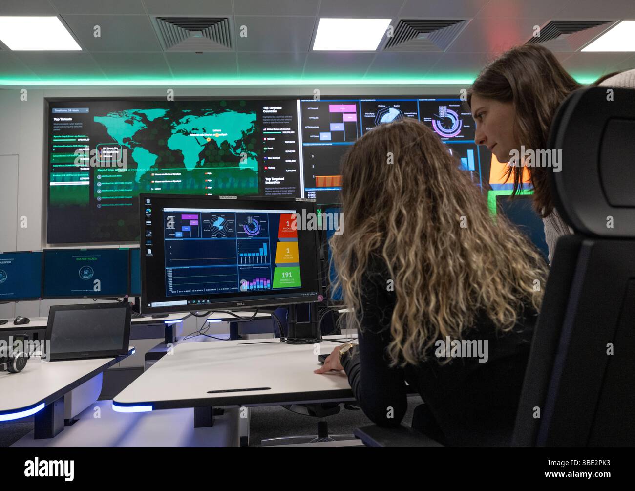 Darmstadt, Germany. 27th May, 2025. Two employees sit at monitors in ...