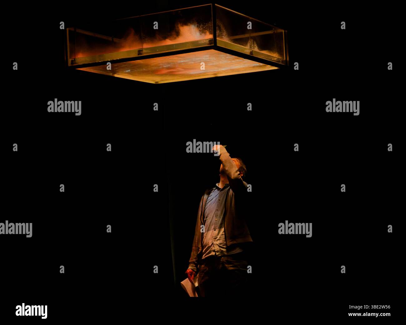 Man takes a photo while absorbed in the shifting lights of a ceiling ...