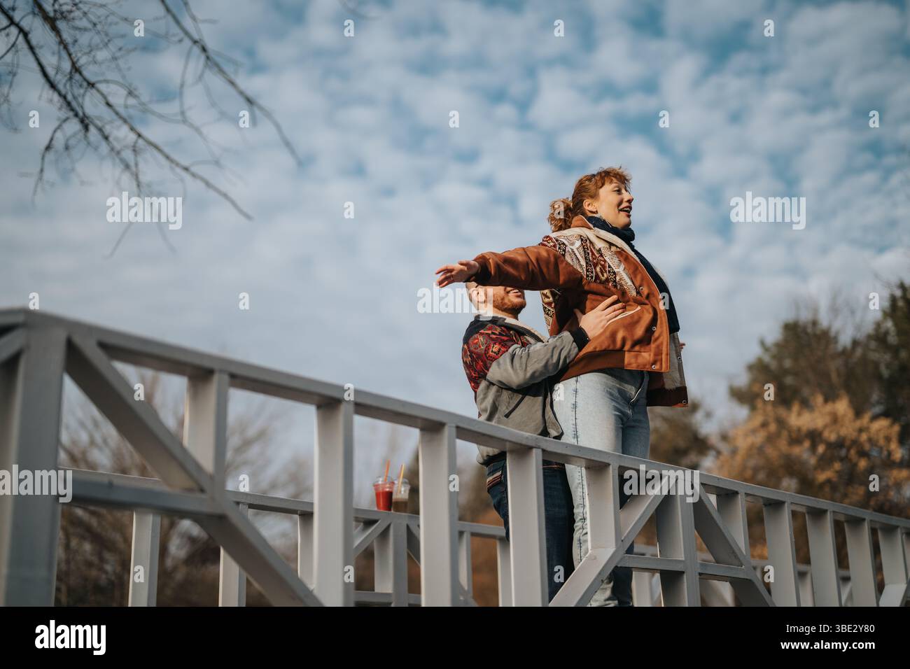 Couple Recreates Iconic Pose on Bridge with a Scenic Background Stock ...