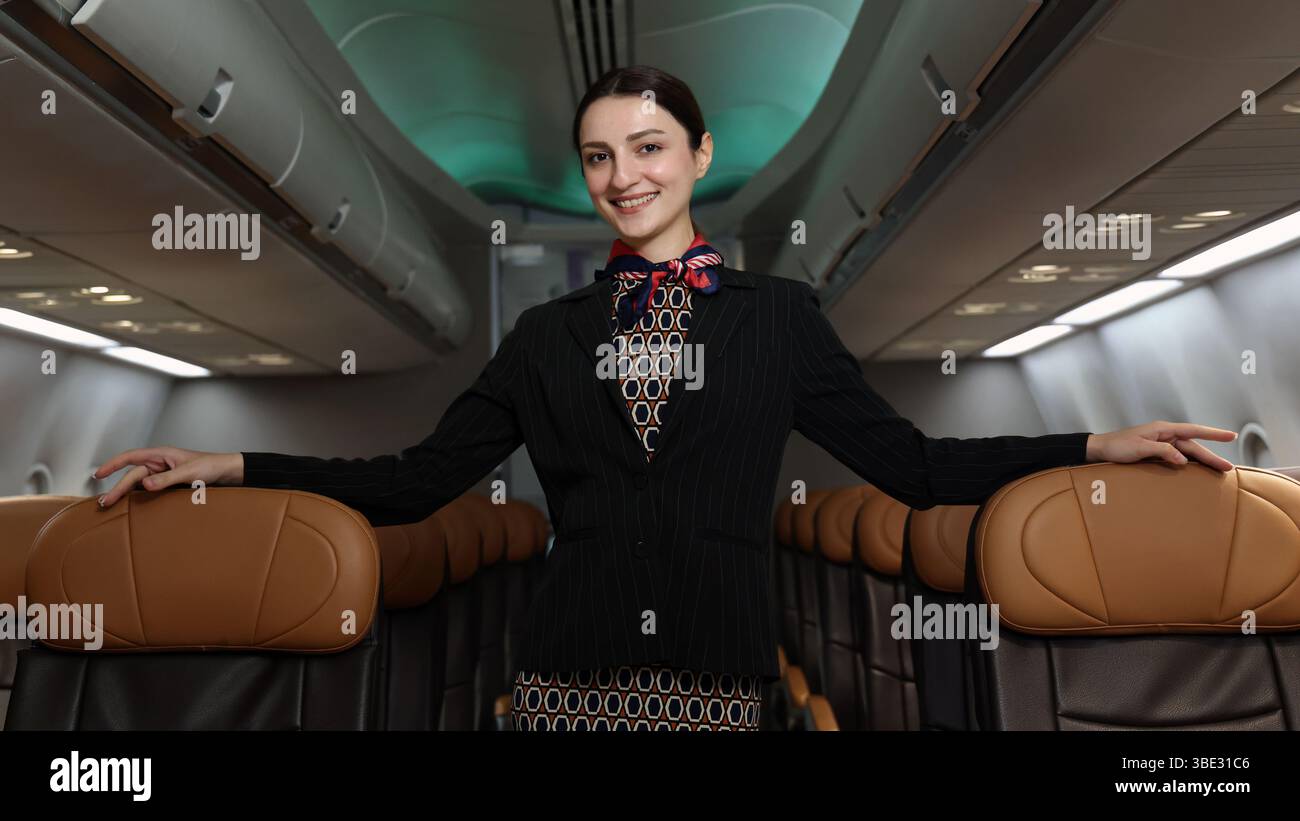 Flight attendant or Air Hostess. A friendly flight attendant stand ...