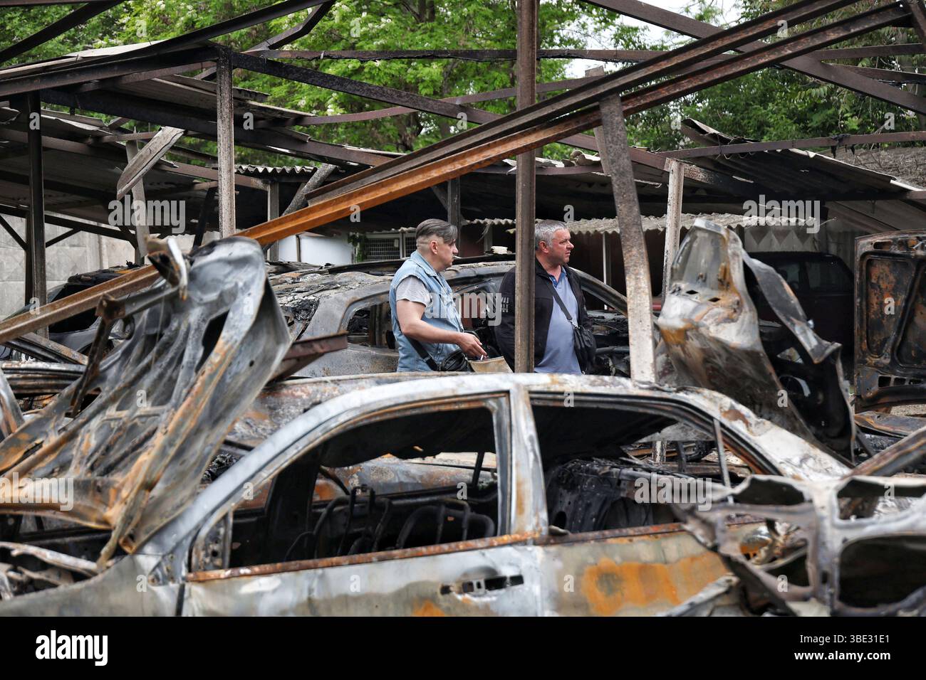 Non Exclusive: People stay by cars destroyed by an overnight Russian ...