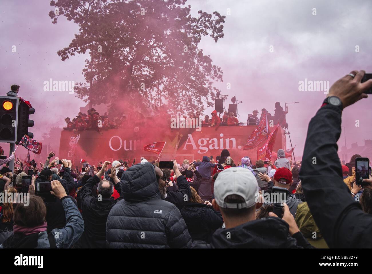 Crowds of Liverpool fans with red smoke bombs and mobile phones on ...