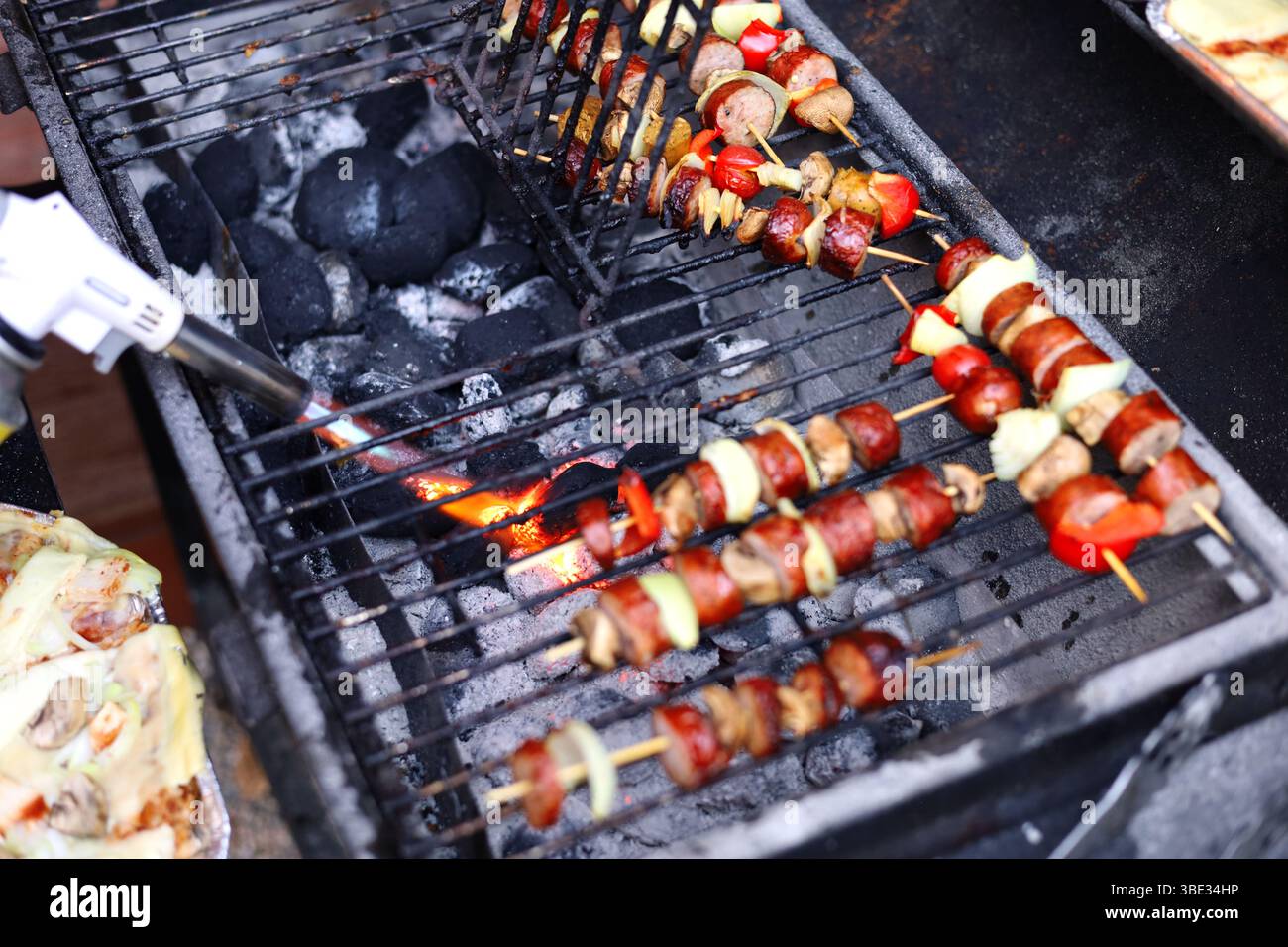 Large metal grill fired with a gas burner. Grilled cheese and colorful ...