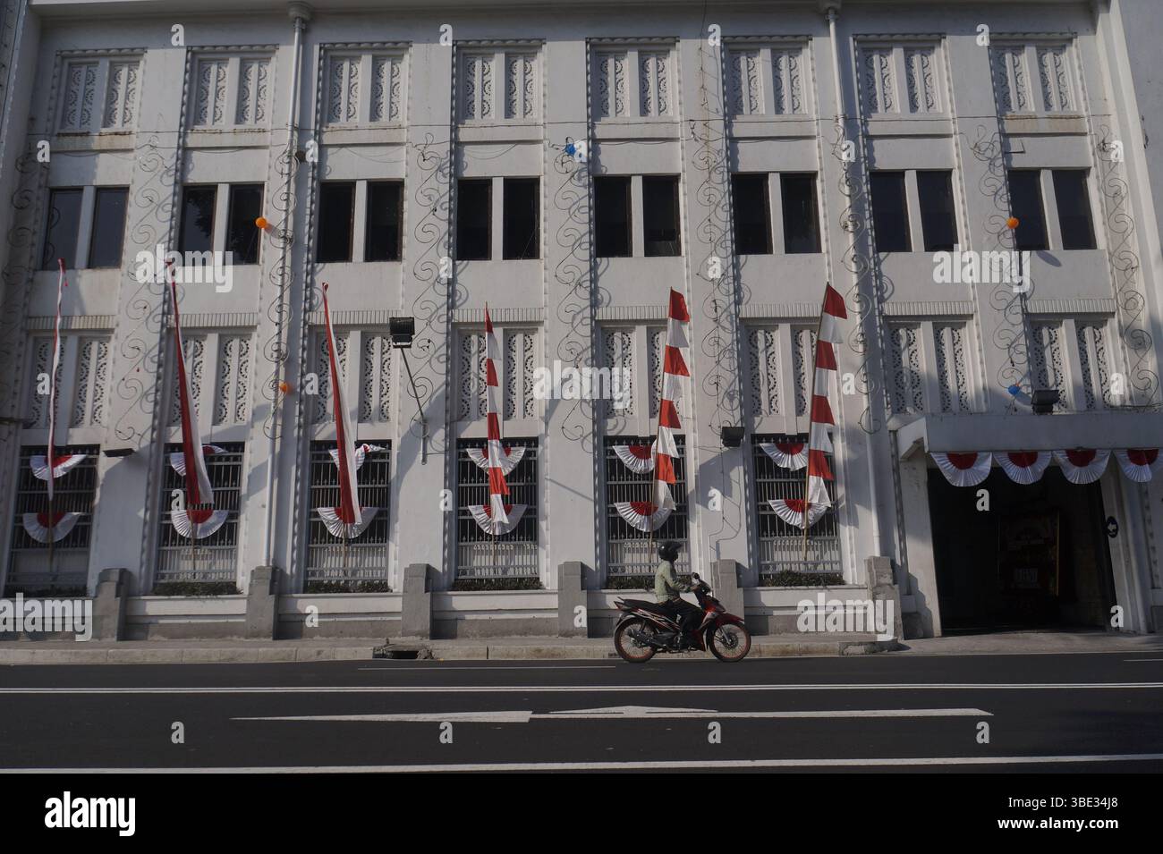 Motorcycle pass through European-style historic buildings in the city ...