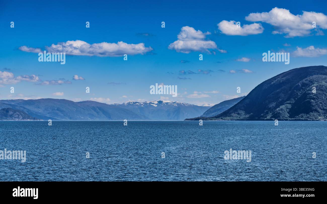 Tranquil ocean scene featuring glistening water, overlapping mountain ...