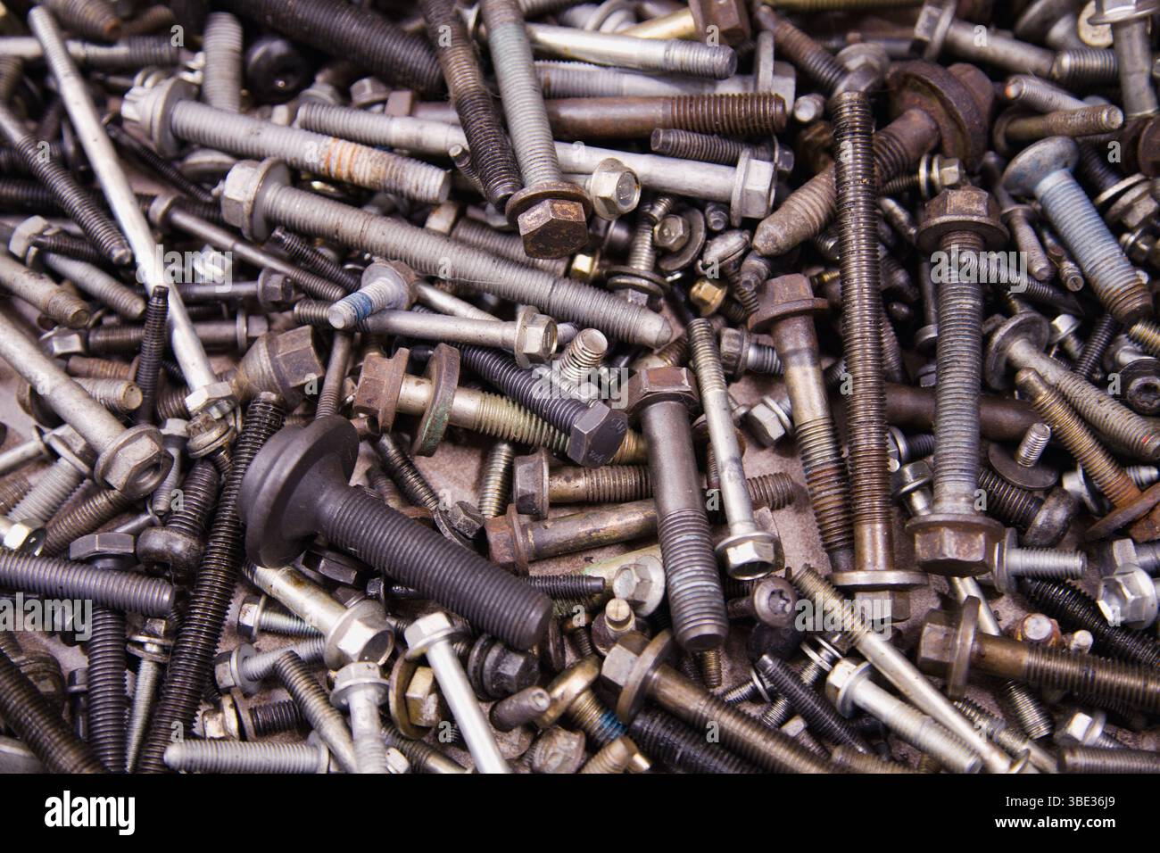 Scattered bolts and screws of different sizes forming an industrial background Stock Photo - Alamy