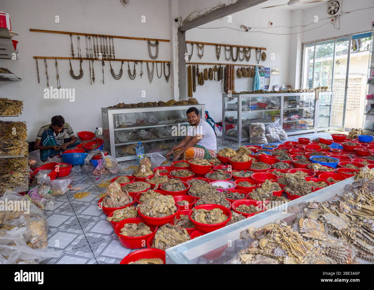 Metal worker using old lost wax casting method to create jewels, Dhaka Division, Dhamrai ...