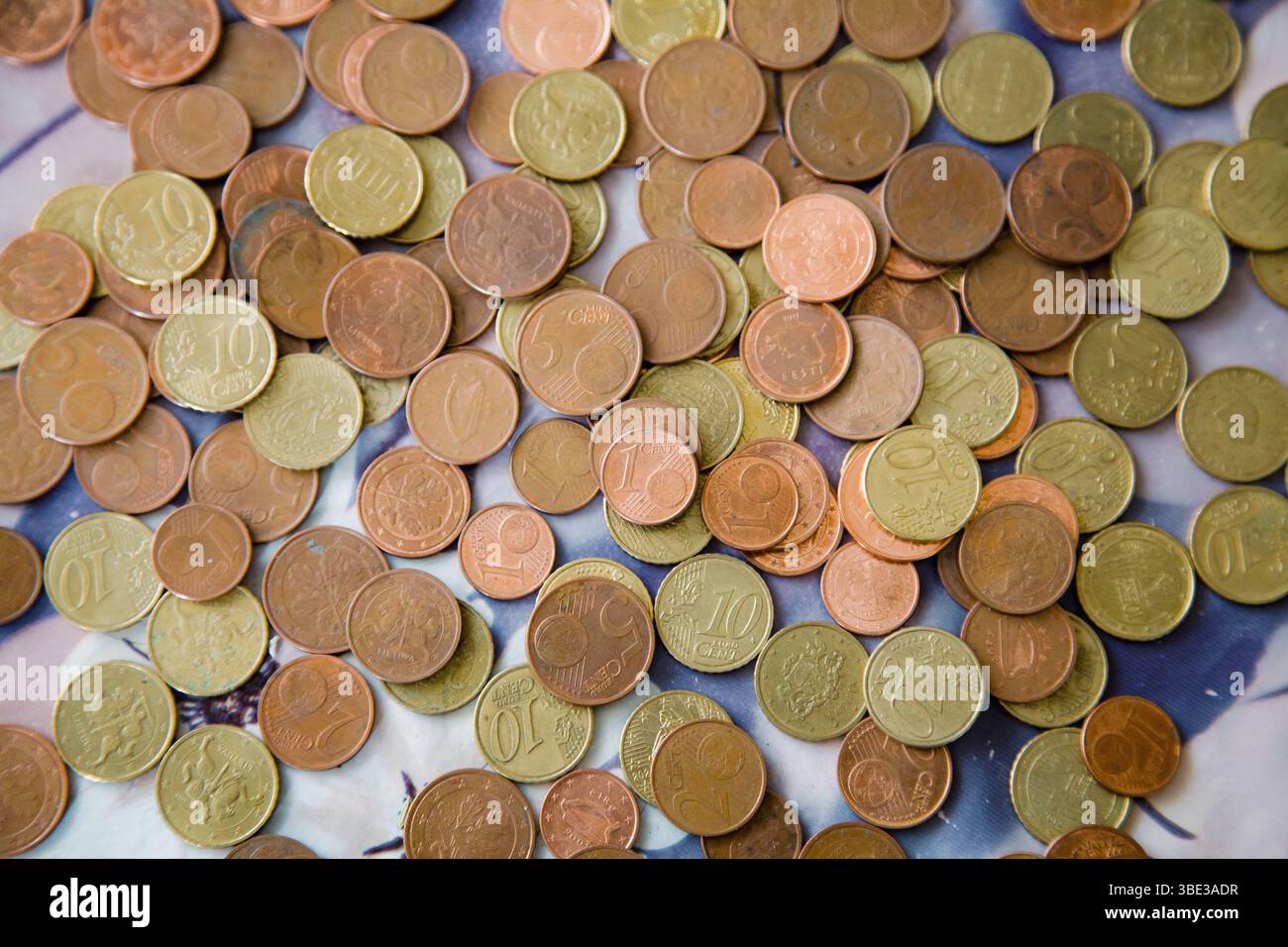 Scattered euro cent coins in warm golden-red tones - denominations of 1 ...