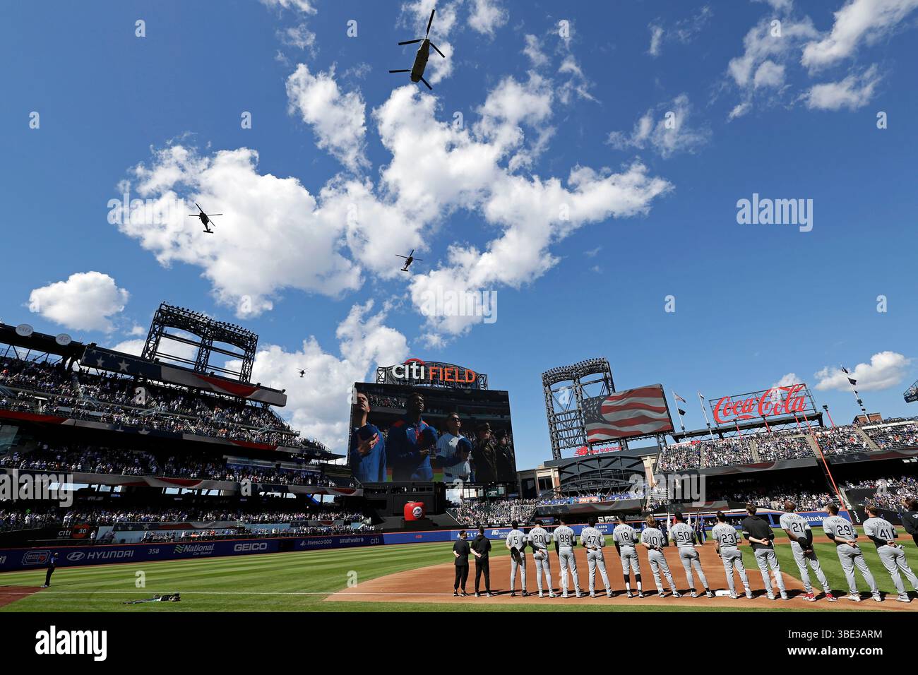 United States Army helicopters perform a flyover before a baseball game ...