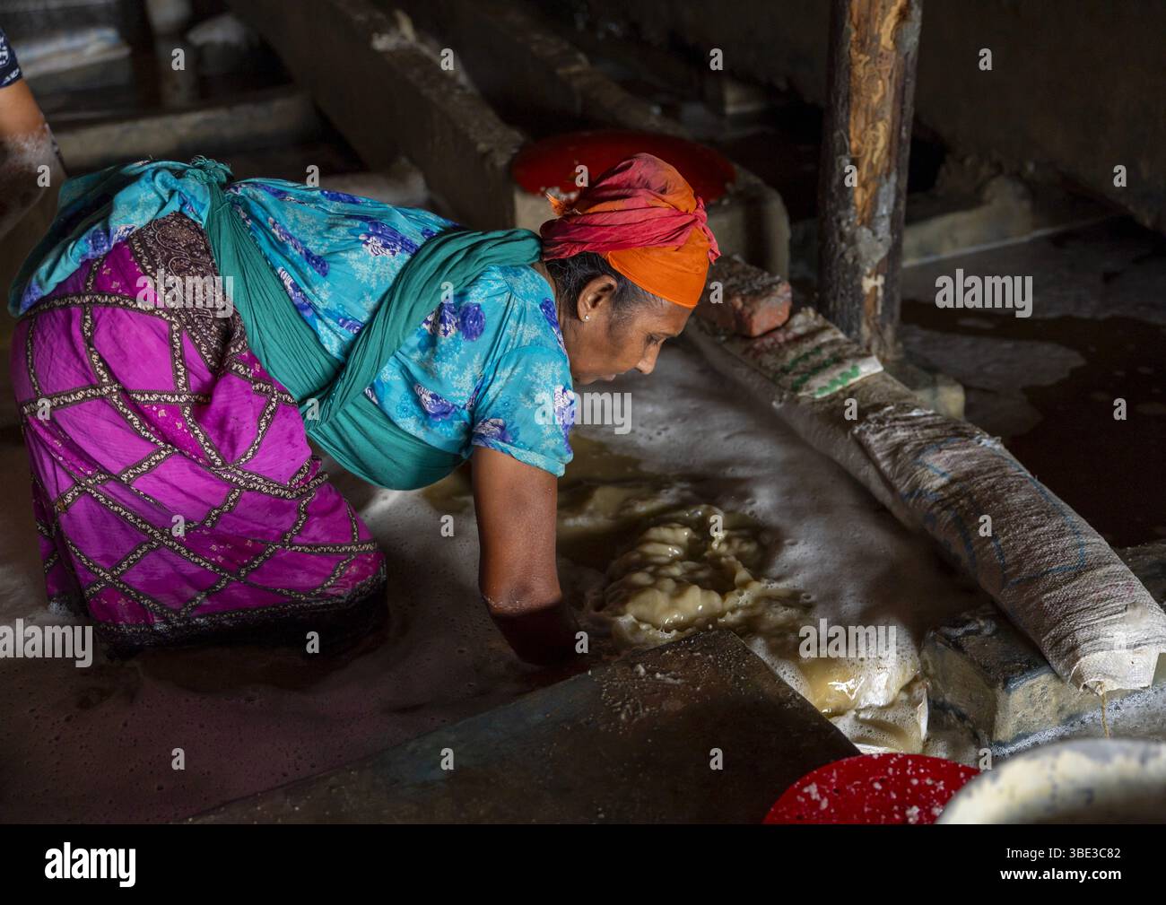 Bangladeshi woman washing salt in water in a factory, Chittagong ...