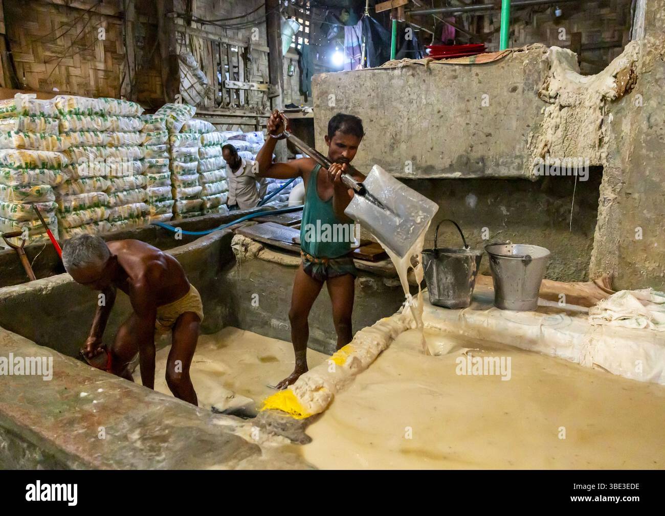 Bangladeshi men washing salt in water in a factory, Chittagong Division ...