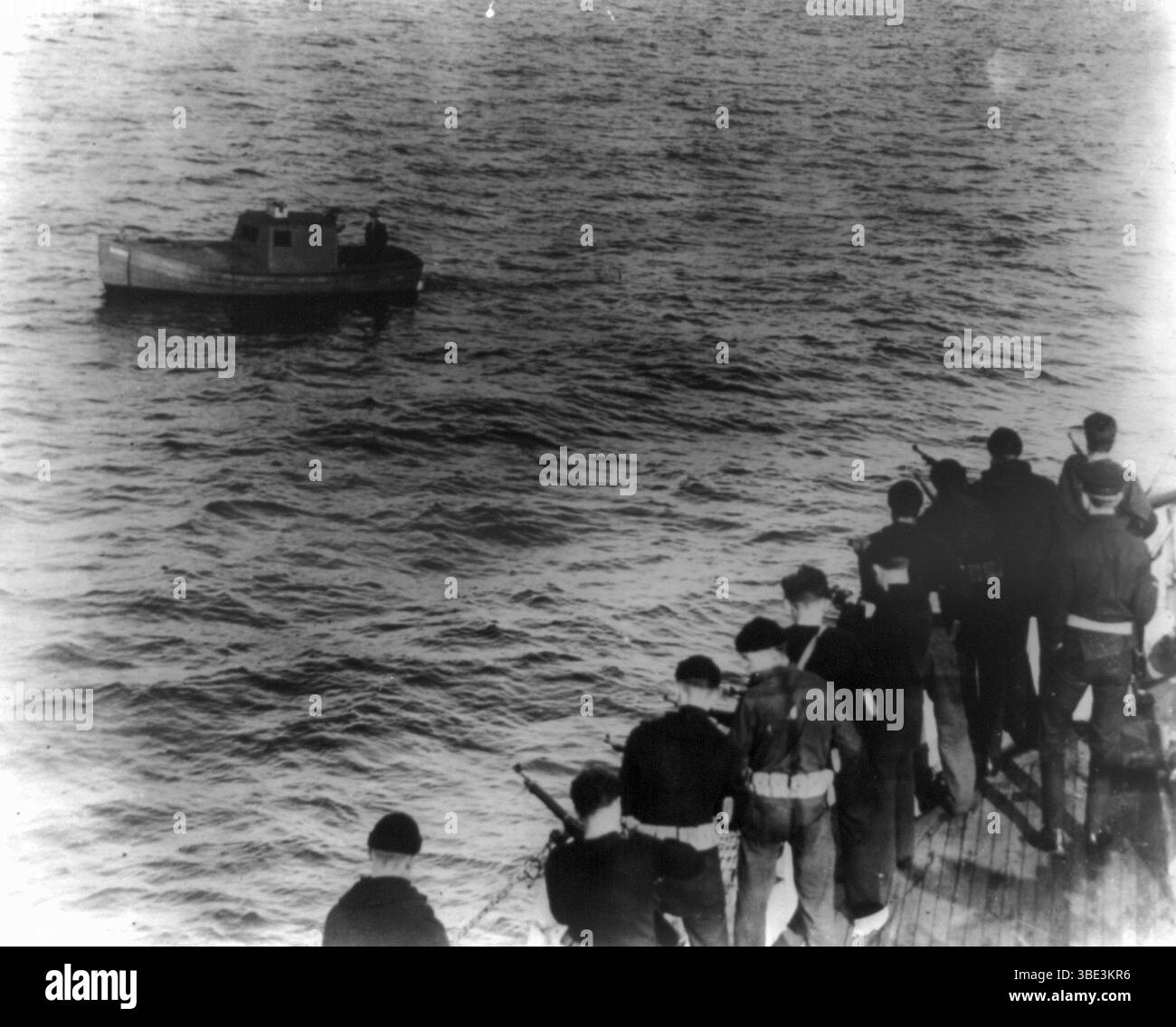 Armed Prohibition enforcement agents firing at a rum runner from the US ...
