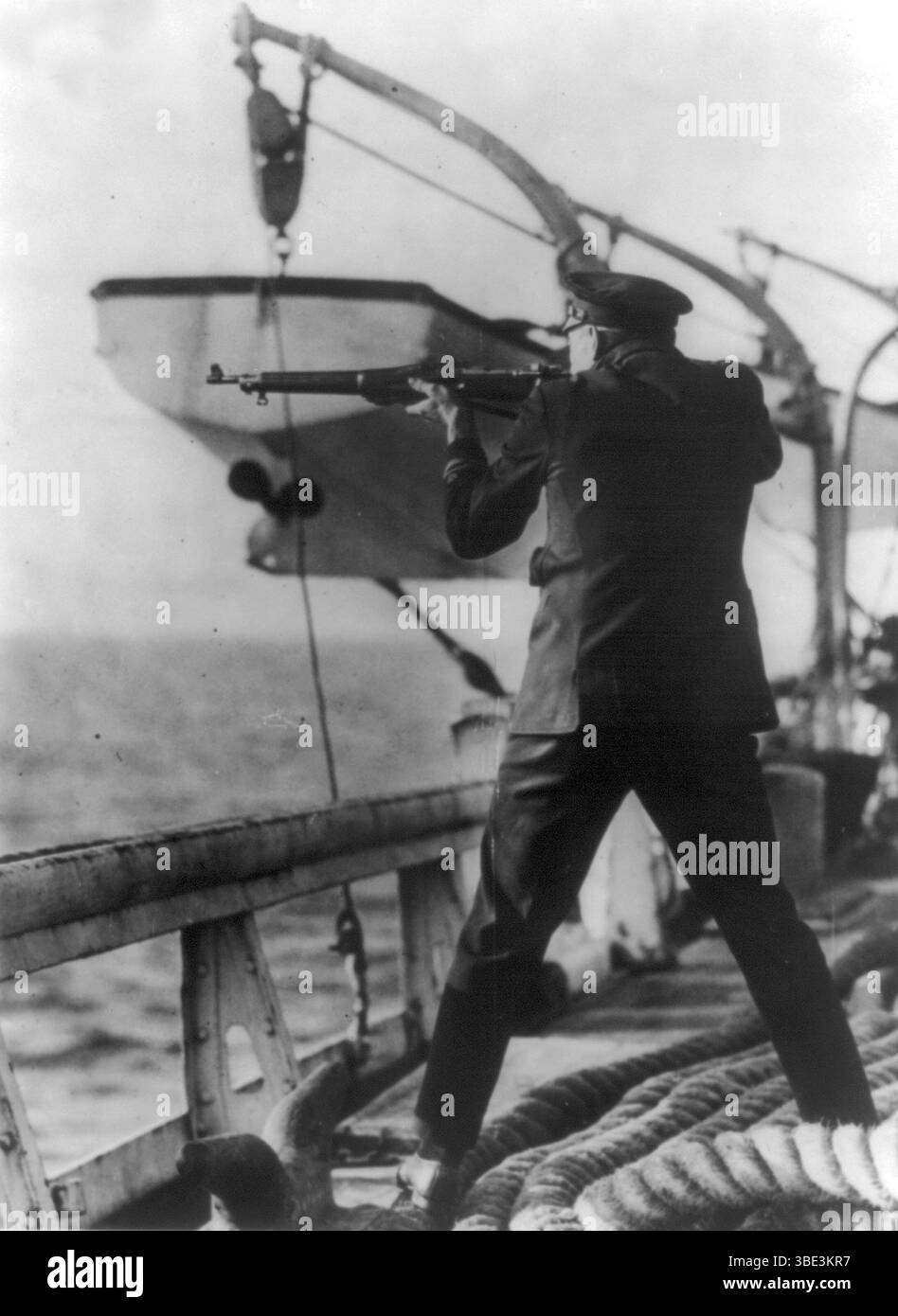 Armed Prohibition enforcement agents firing at a rum runner from the US ...