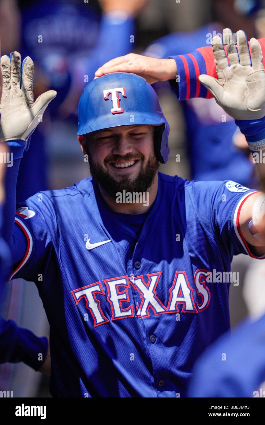 Texas Rangers first baseman Jake Burger (21) is congratulated after ...