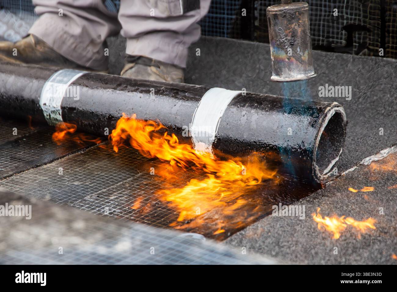 Roofer during waterproofing work with bitumen membranes Stock Photo - Alamy