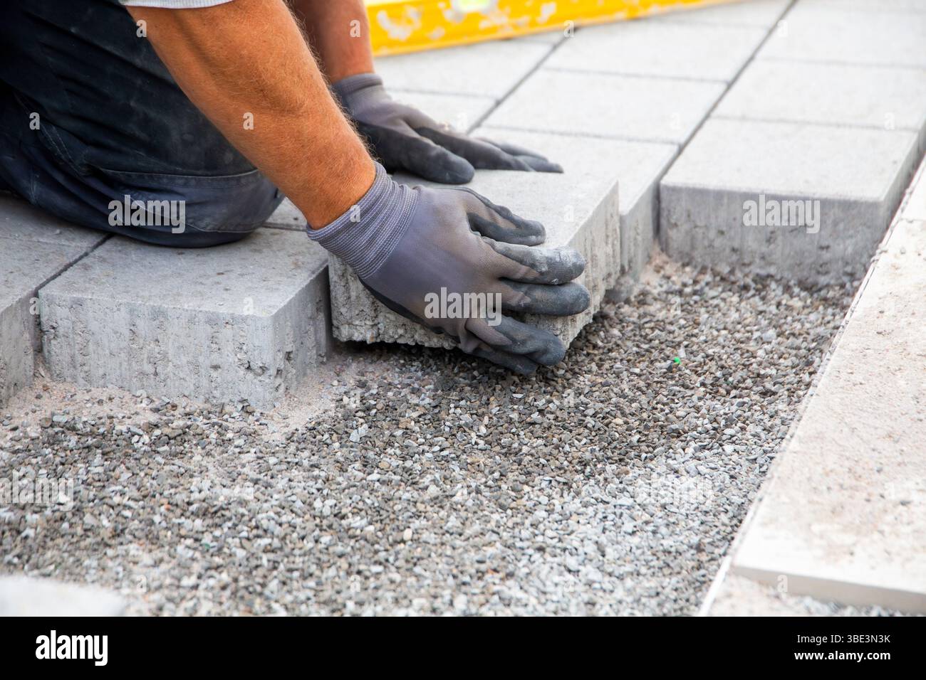 Craftsmen lay paving stones in the garden Stock Photo - Alamy