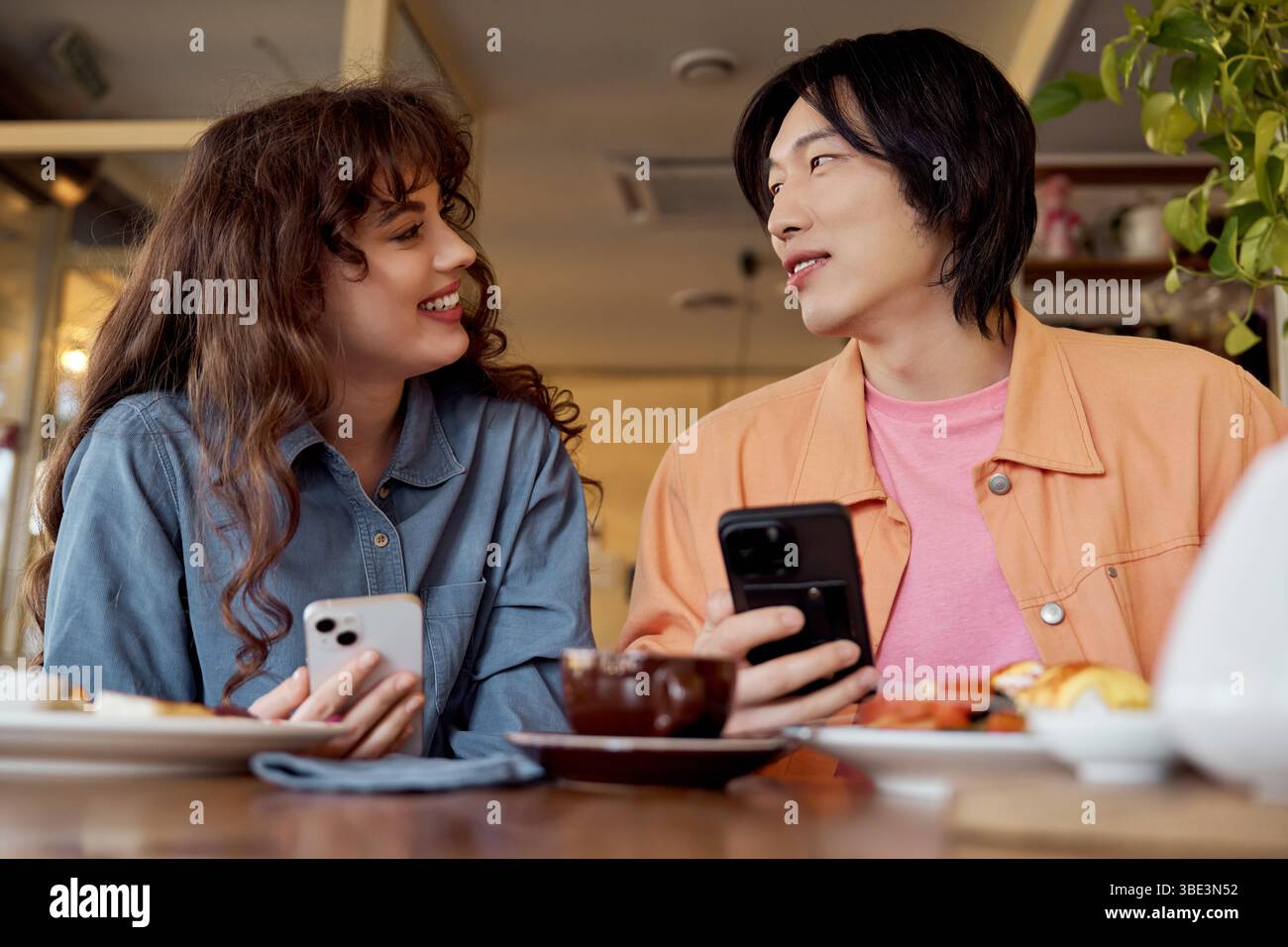 Two friends enjoy a lovely moment together, sharing smiles and ...