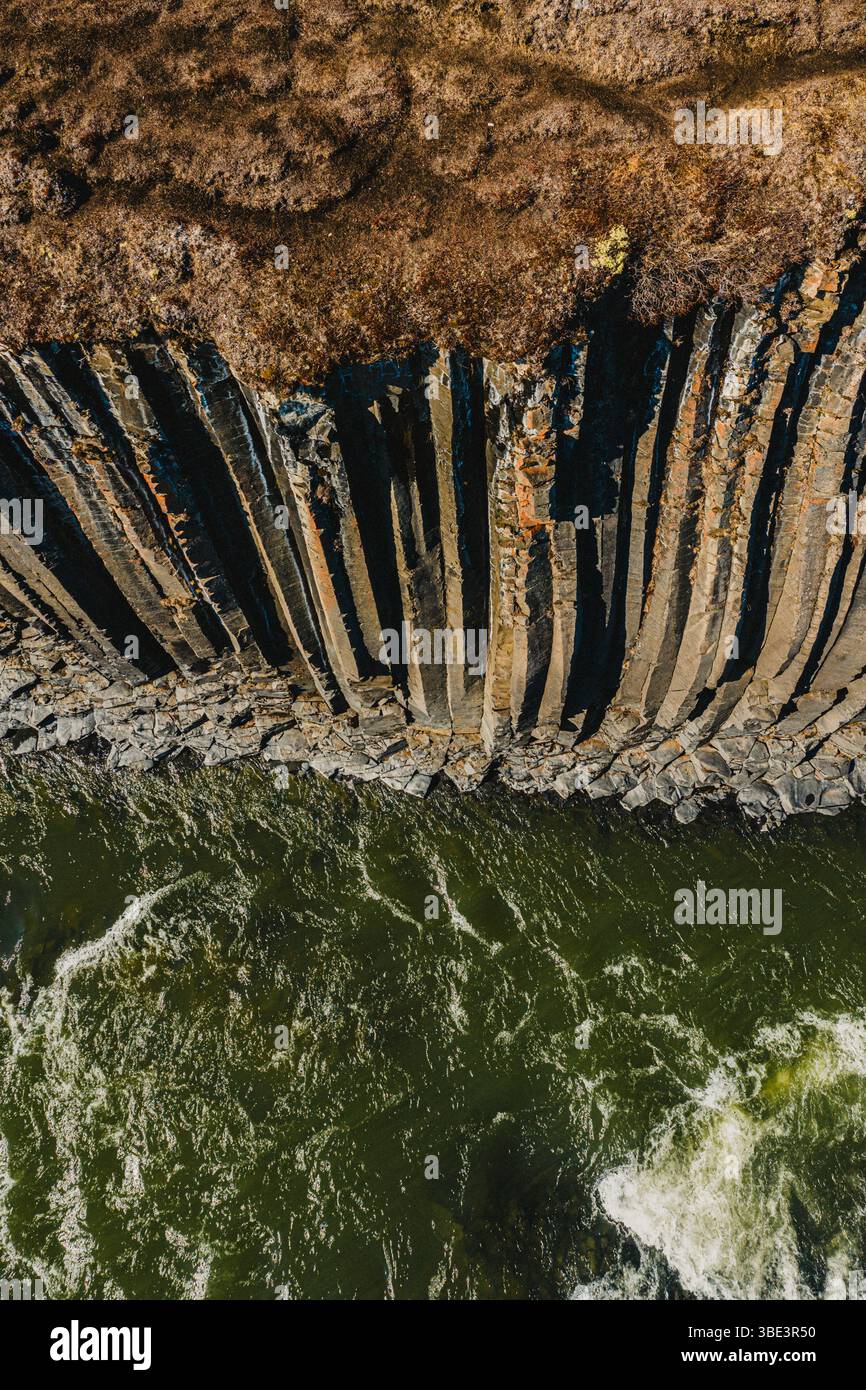 Aerial view of basalt columns and glacial river at Studlagil Canyon ...