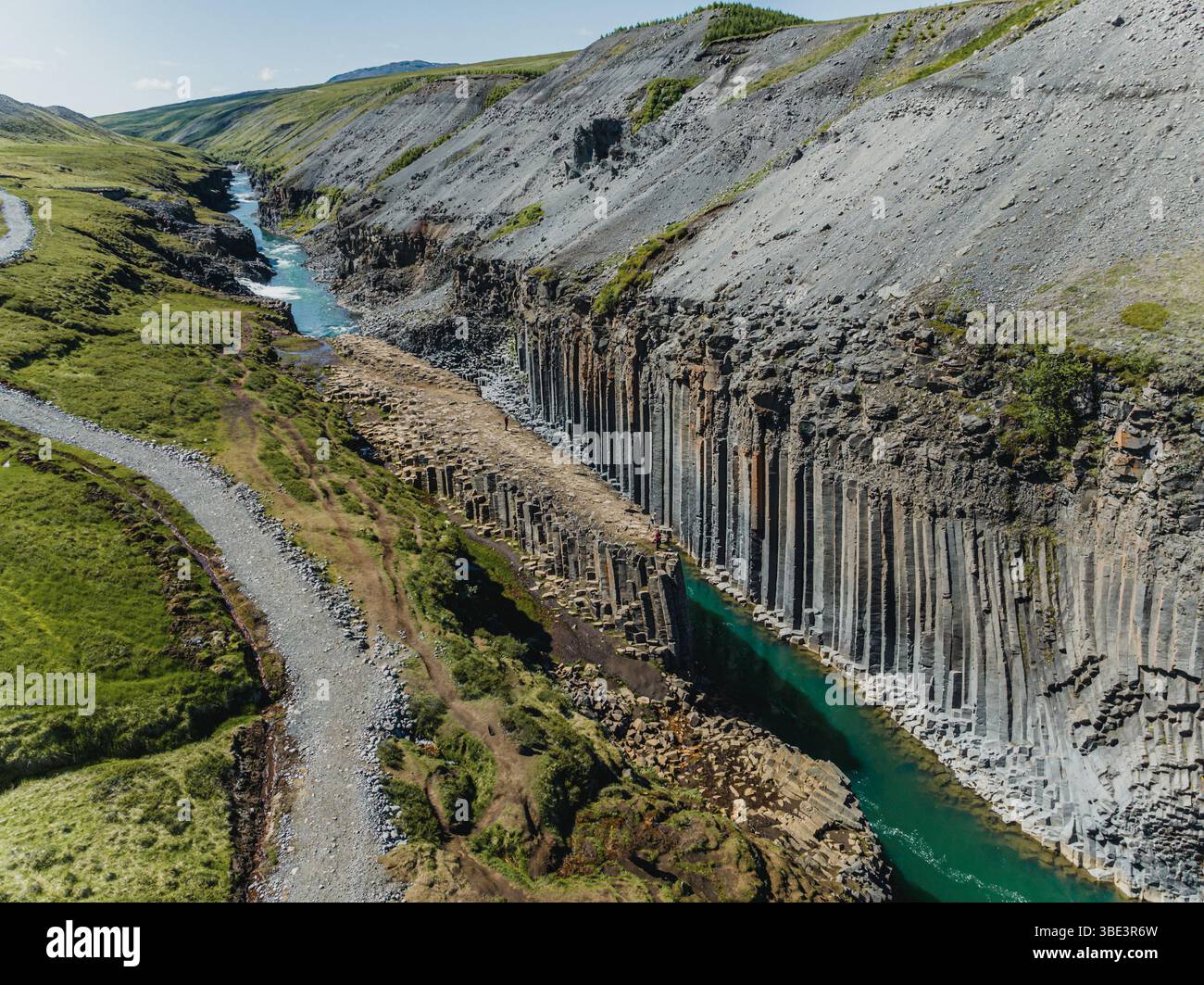 Aerial view of basalt columns and blue river in Studlagil Canyon ...