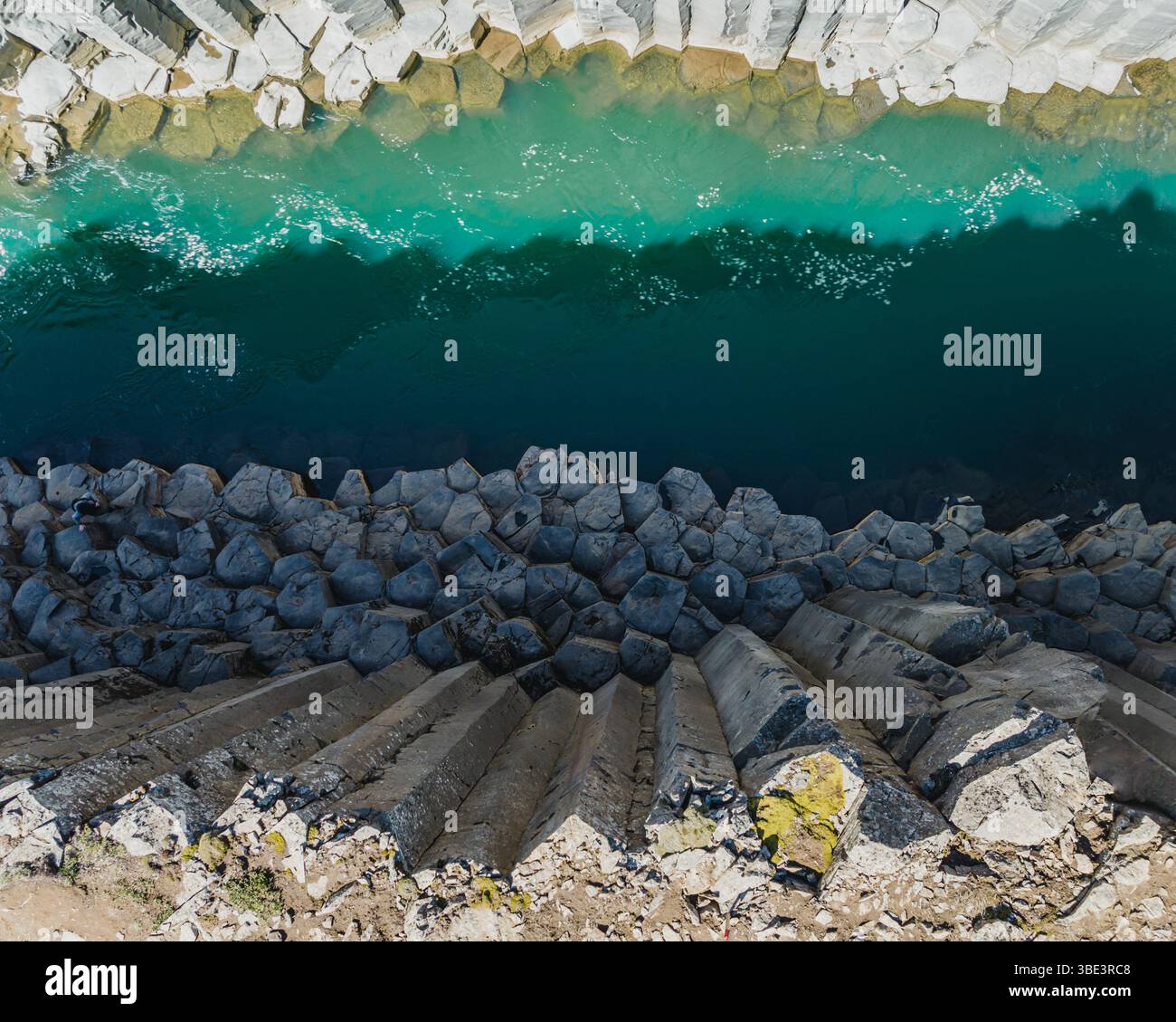 Aerial view of basalt columns and turquoise river in Studlagil Canyon ...
