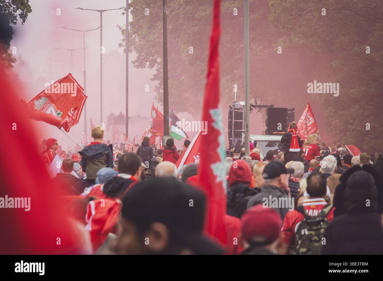 Crowds of Liverpool fans with red smoke bombs and flags on Queens Drive ...
