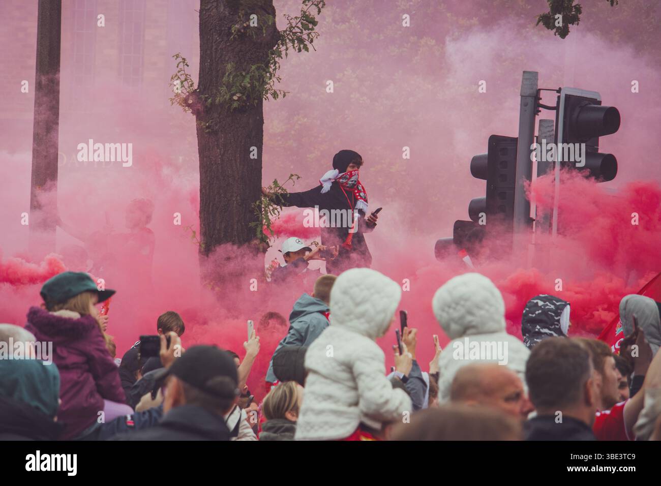 Crowds of Liverpool fans with red smoke bombs and mobile phones on ...