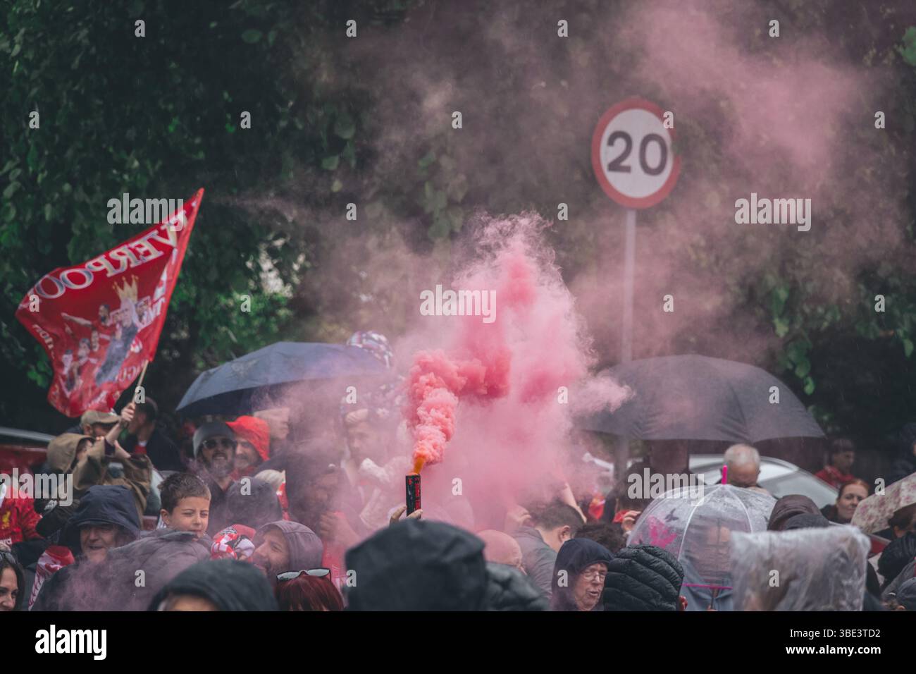 Crowds of Liverpool fans with red smoke bombs and flags on Queens Drive ...