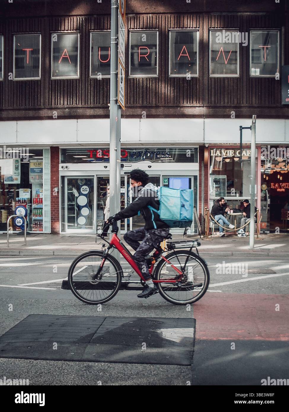 Deliveroo delivery bike and rider with the company logo visible on the ...