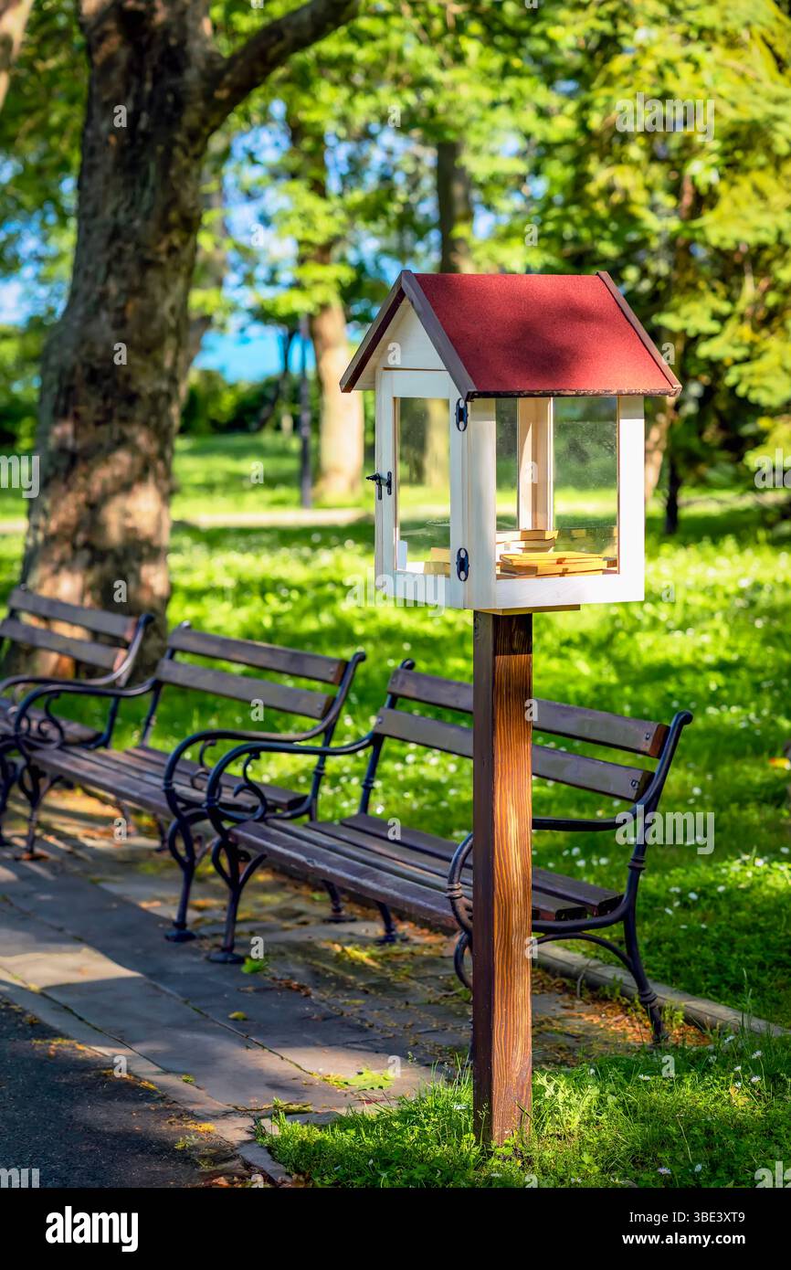 Wooden free mini library booth. Small free library with glass doors and ...