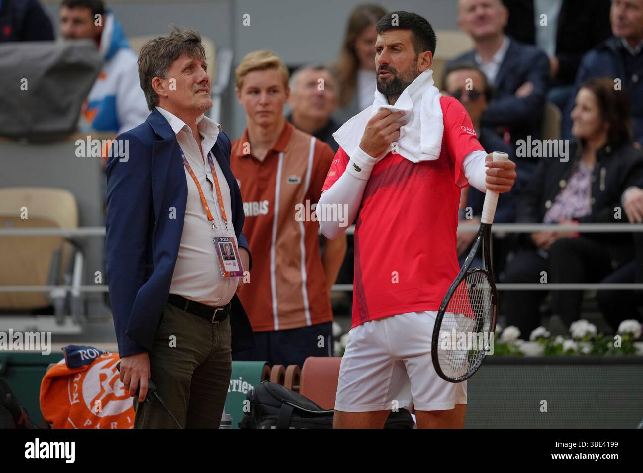 Serbia's Novak Djokovic talks with officials as he plays Mackenzie ...
