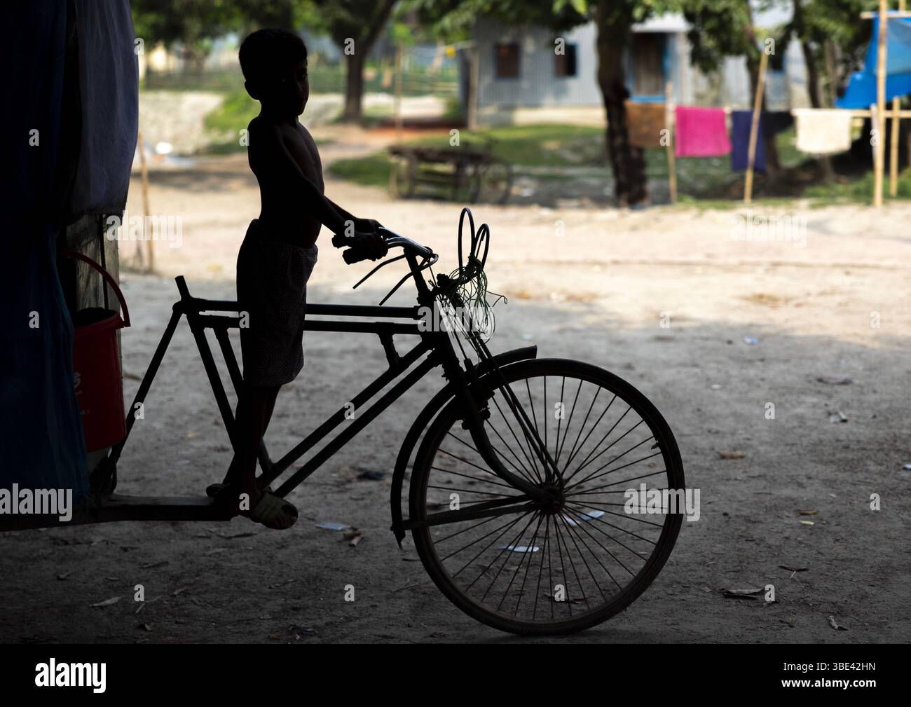 Silhouette of a boy riding a rickshaw, Dhaka Division, Shivalaya, Bangladesh Stock Photo - Alamy