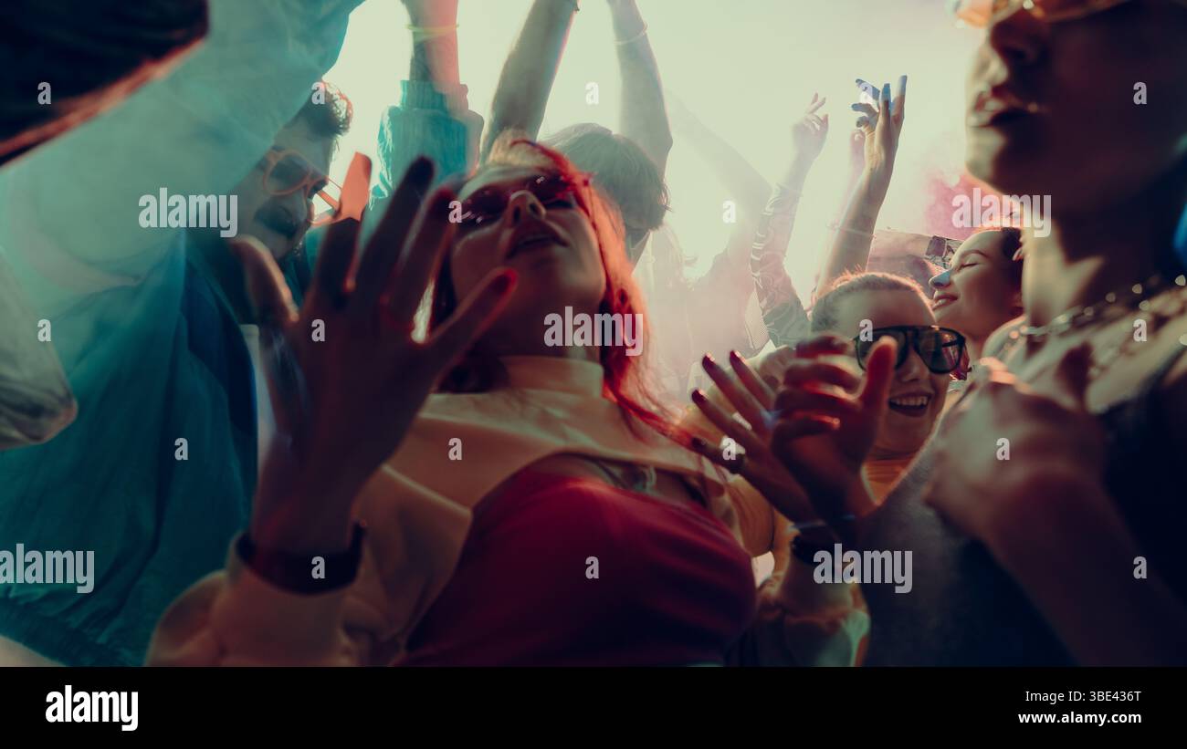 A lively party scene with people dancing energetically in vibrant ...