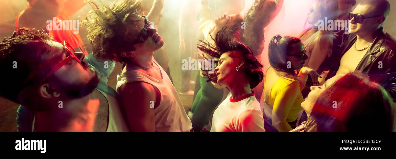 A lively party scene with a group of people dancing under colorful ...