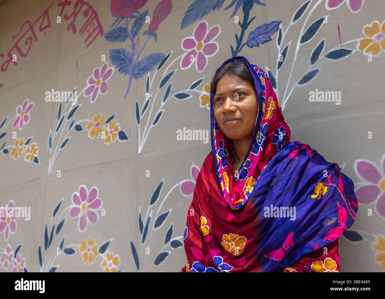 Christian woman from Santal ethnic group in front of a wall painting ...