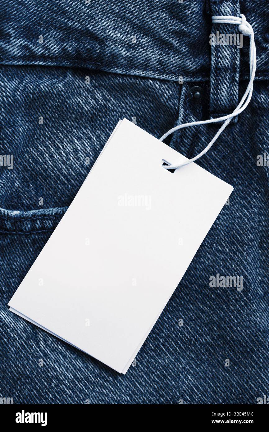 Blank white label on denim jeans. Price tag with string. Close-up of ...