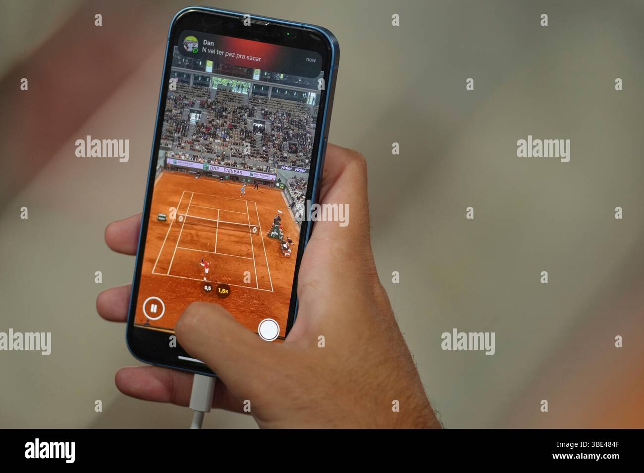 A spectator takes photos of Serbia's Novak Djokovic and Mackenzie ...