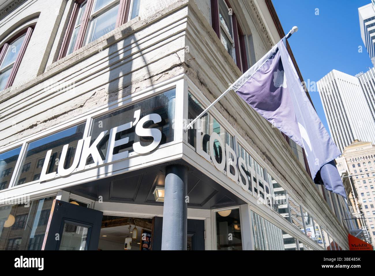 Corner exterior of Luke's Lobster with signage and flag on a sunny day ...
