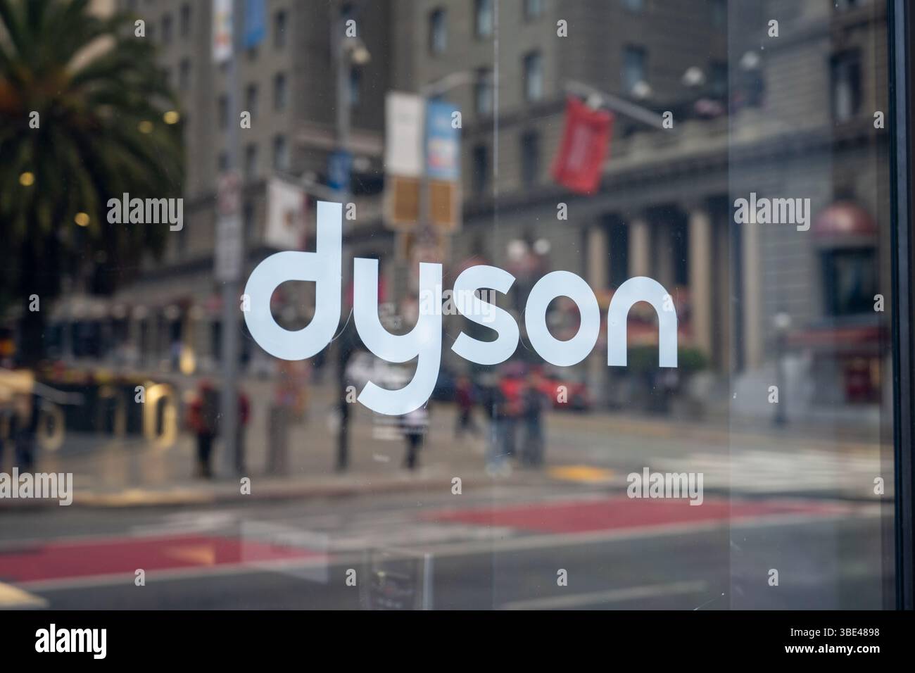 Dyson logo on glass storefront window with busy downtown street ...