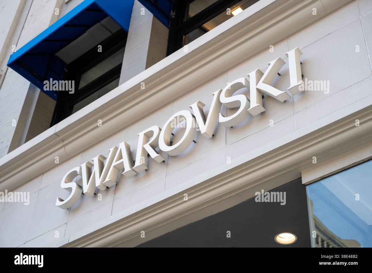 Swarovski store sign on white facade with blue awning, San Francisco ...