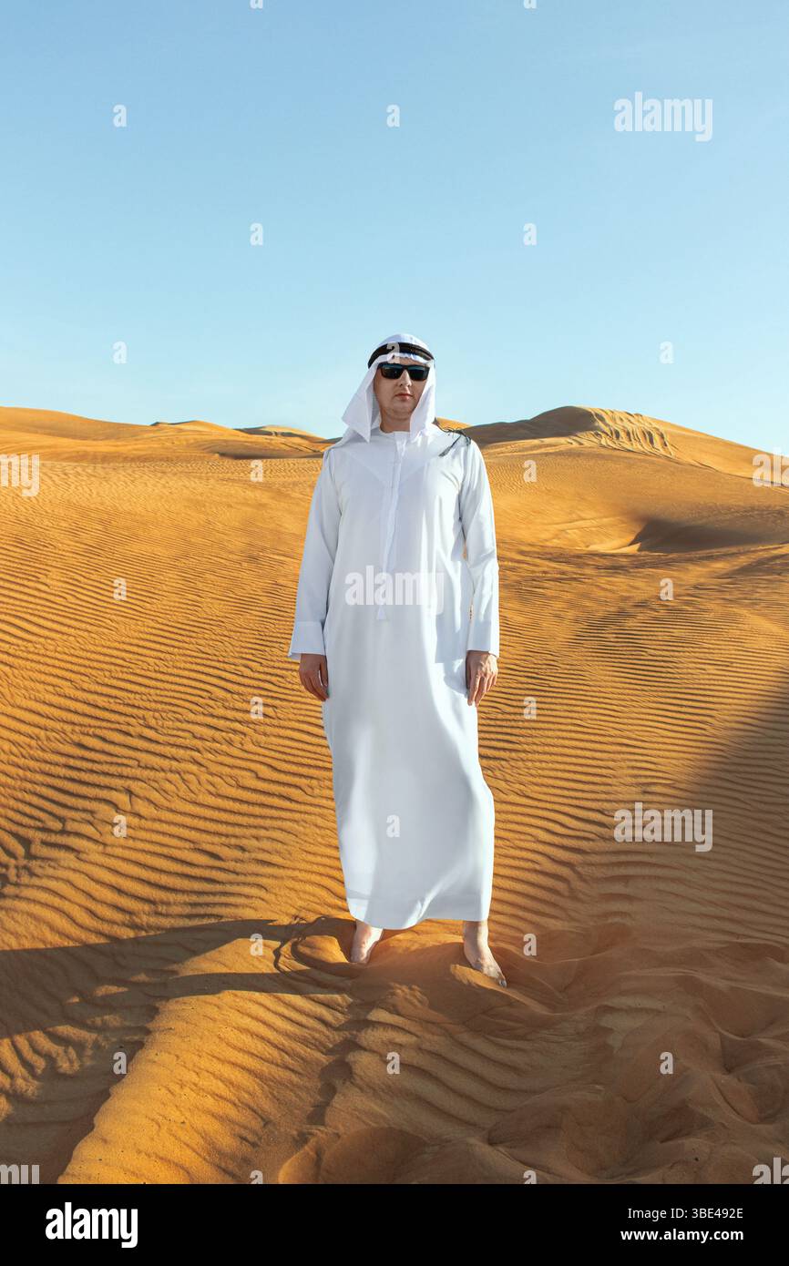 Arabian sheikh in long white dress closeup in the middle of Dubai ...