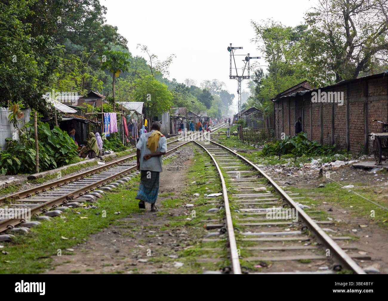 Bangladeshi people living along a railway track in a slum, Rangpur Division, Rangpur, Bangladesh ...