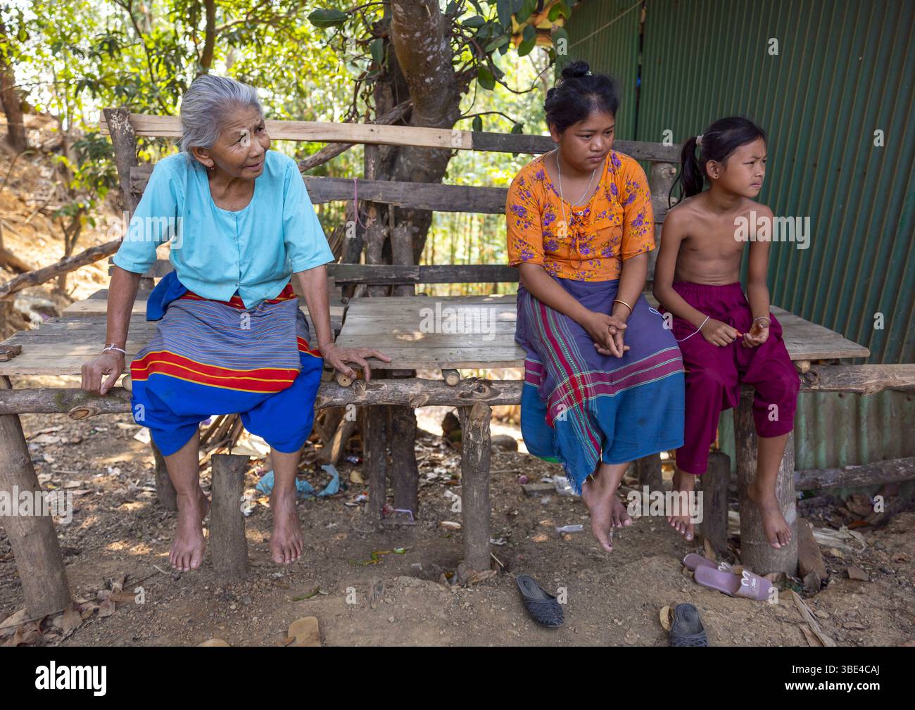 Tanchangya ethnic group women sit on a bench in the street, Chittagong ...