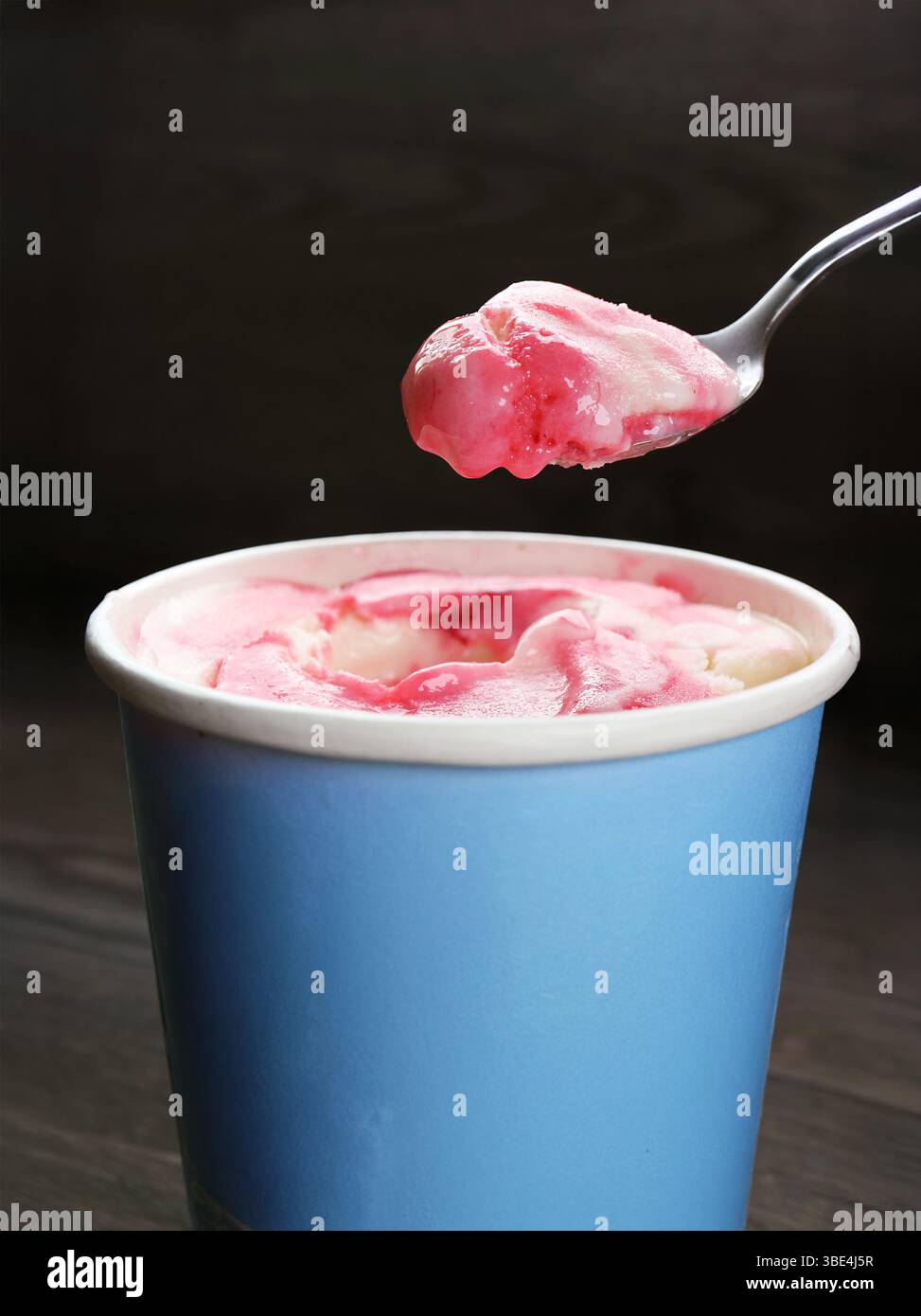 Spoon scooping delectable strawberry yogurt ice cream Stock Photo - Alamy