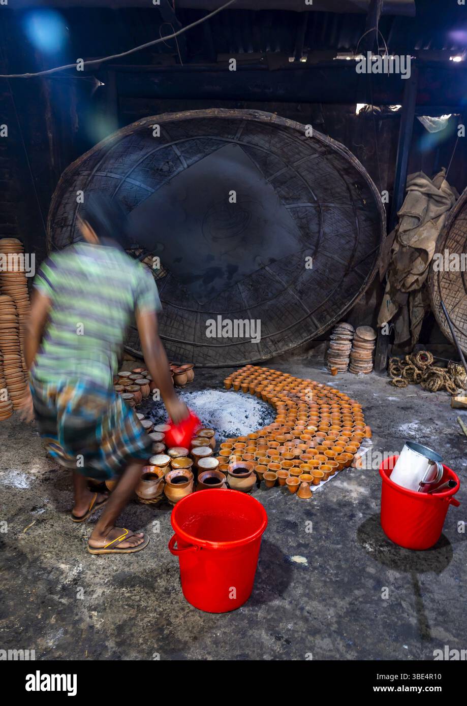 Clay pots around a bonfire to make traditional yogurt, Rajshahi ...