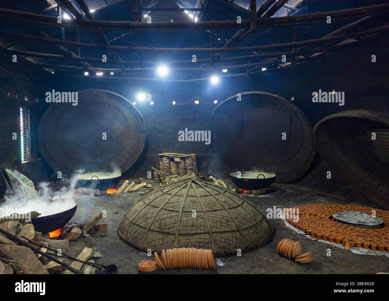 Clay pots around a bonfire to make traditional yogurt, Rajshahi ...