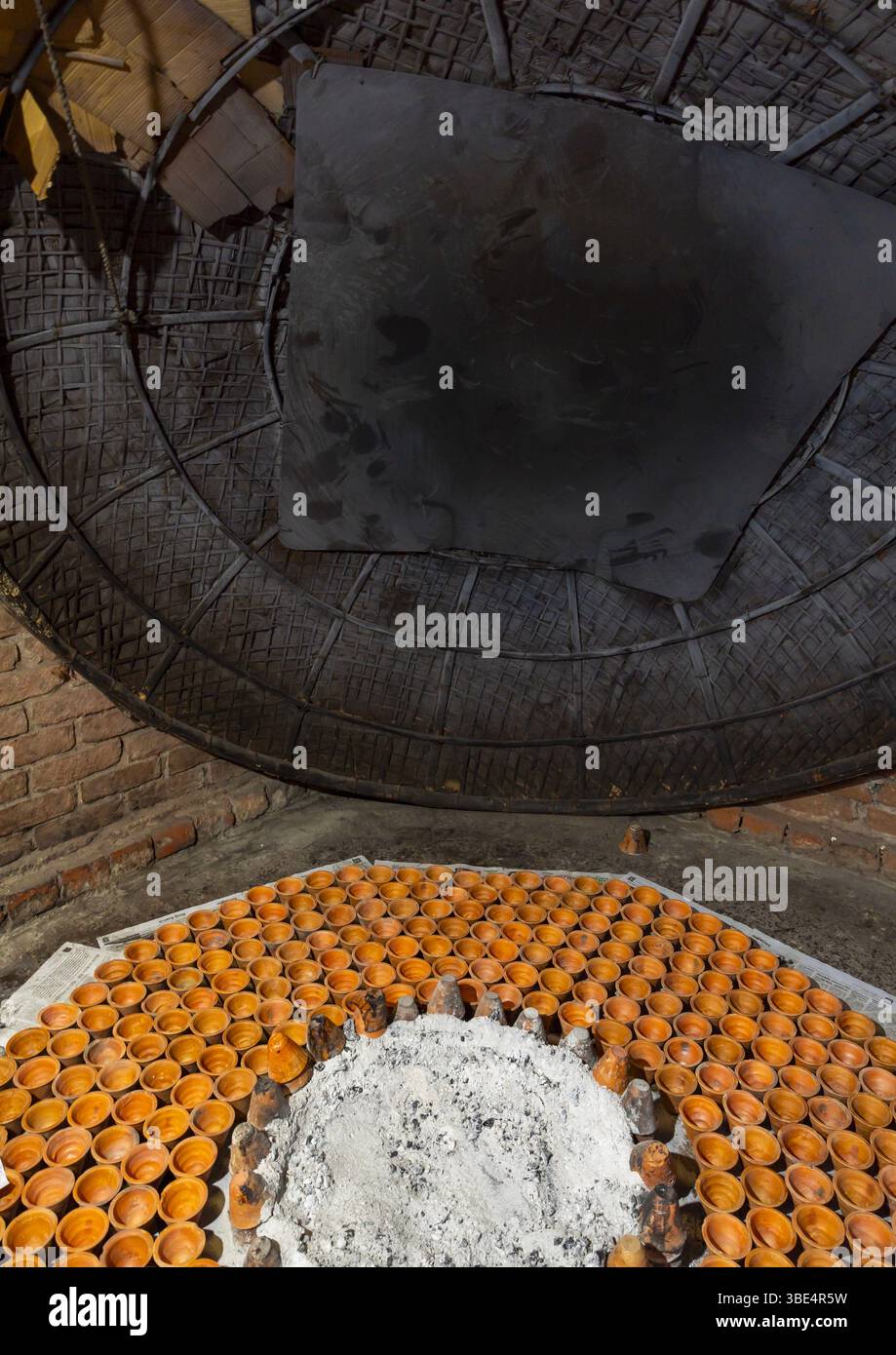 Clay pots around a bonfire to make traditional yogurt, Rajshahi ...