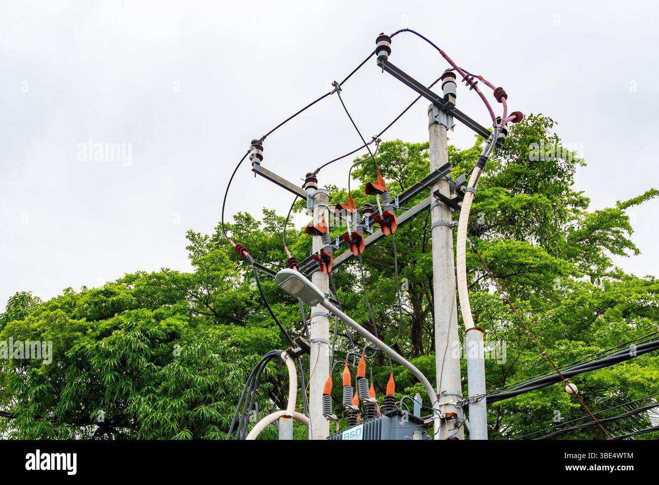 Tall power pole with many wires coming out of it. The pole is ...