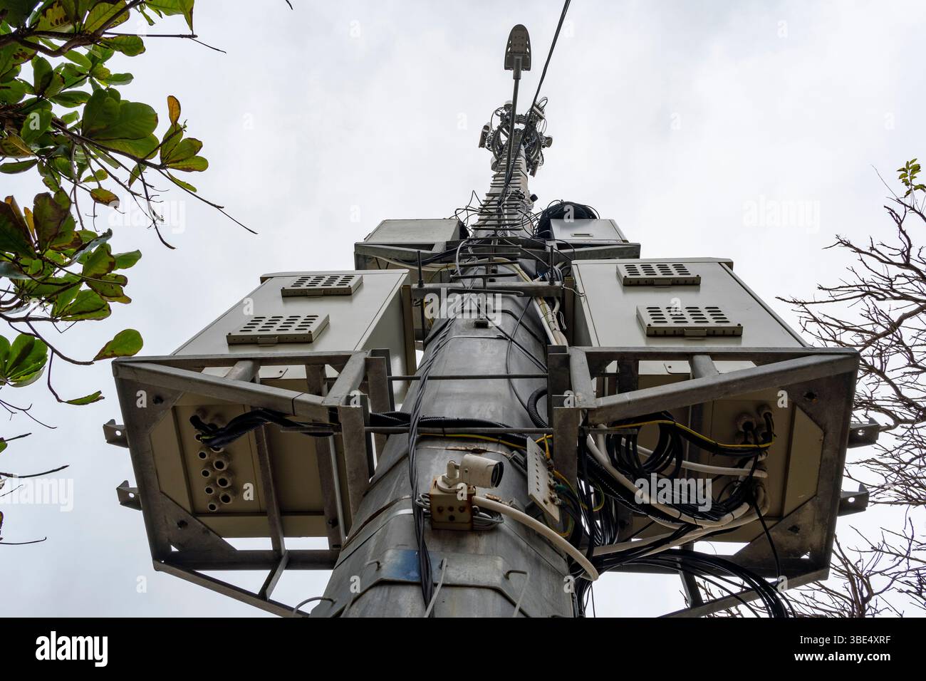 Tall power pole with many wires coming out of it. The pole is ...