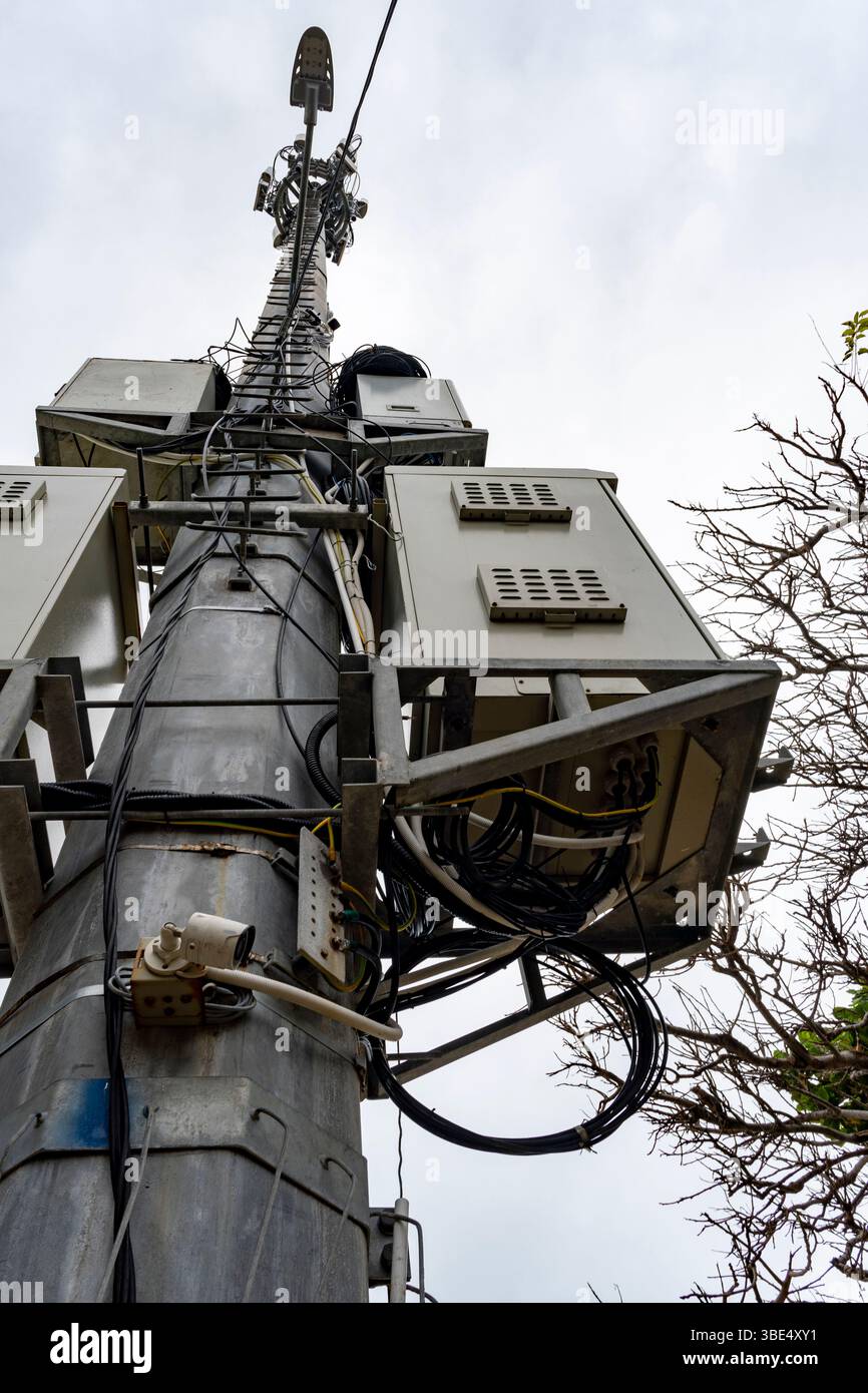 Tall power pole with many wires coming out of it. The pole is ...
