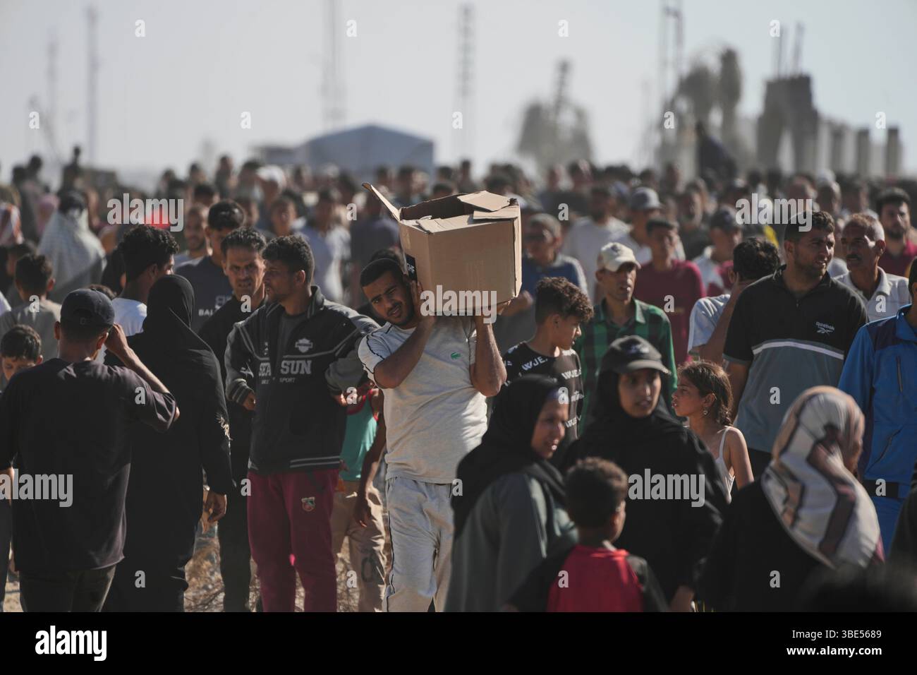 Palestinians carry boxes containing food and humanitarian aid packages ...